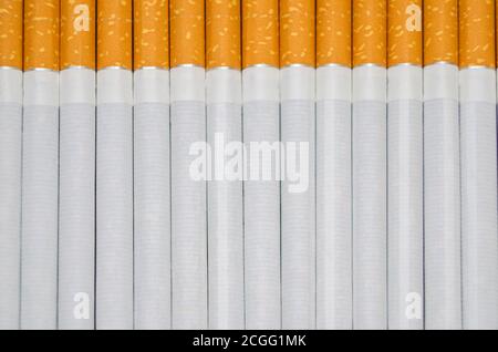 Horizontal background from a number of cigarettes Stock Photo - Alamy