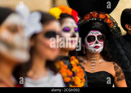 Young women, dressed as La Catrina, take part in the Day of the Dead ...