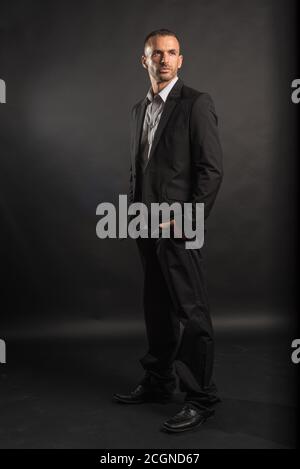 Young handsome male employee with too much work in the office Stock ...