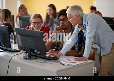 Female professor correcting students at the lecture in the university ...