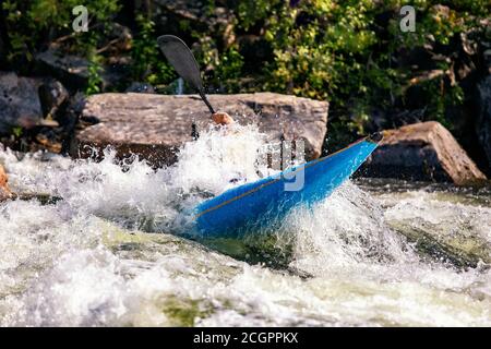 Guy in kayak sails mountain river. Whitewater kayaking, extreme sport ...