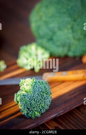 Fresh broccoli cutted on the kitchen board by knife Stock Photo - Alamy