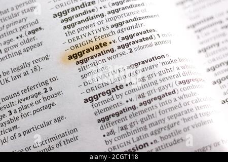 The word or phrase Aggravate in a dictionary highlighted with marker ...