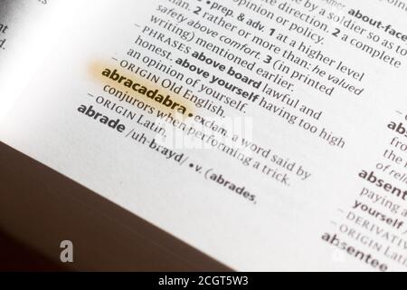 The word or phrase Abracadabra in a dictionary highlighted with marker ...