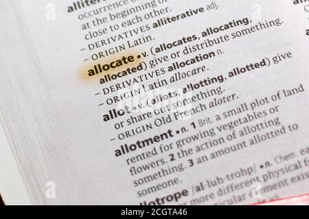 The word or phrase Allocate in a dictionary highlighted with marker ...