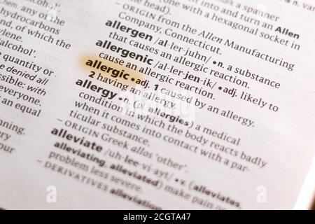 The word or phrase Allergic in a dictionary highlighted with marker ...