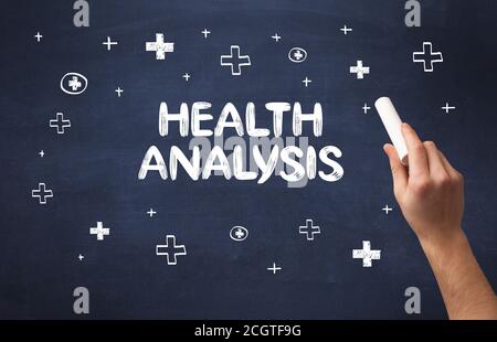 Hand drawing HEALTH ANALYSIS inscription with white chalk on blackboard ...