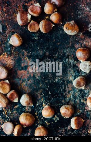 Chestnuts frame on black metal rustic surface Stock Photo - Alamy