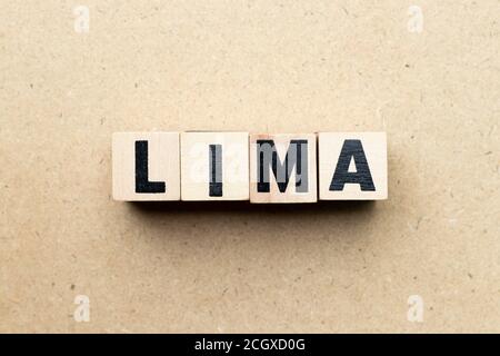 Wood letter in word Lima on green grass background Stock Photo - Alamy