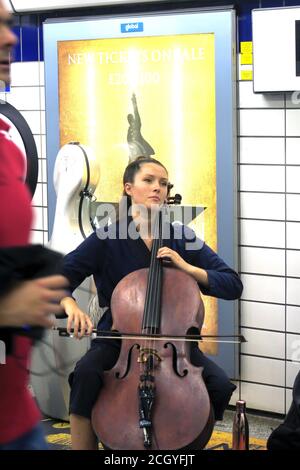 woman cellist busking in London Underground Stock Photo - Alamy
