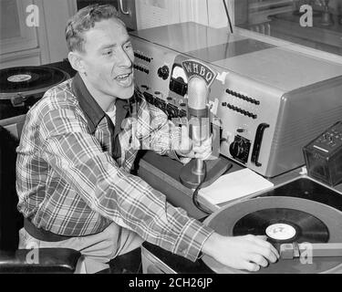 Radio DJ Dewey Phillips sits at the control board at WHBQ Stock Photo ...