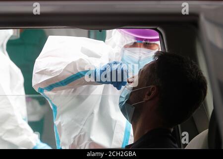 A Coruna-Spain -August 18, 2020: A health worker uses a PCR test (mouth ...