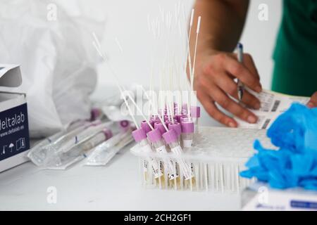 A Coruna-Spain -August 18, 2020: A health worker uses a PCR test (mouth ...