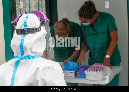 A Coruna-Spain -August 18, 2020: A health worker uses a PCR test (mouth ...
