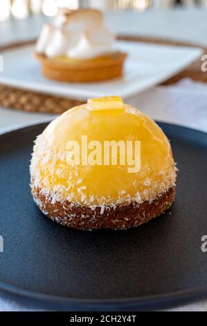 Small yellow lemon ball tart from French pastry shop close up Stock ...