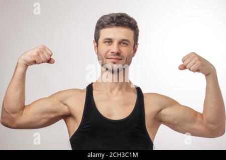 Muscular strong well built men bodybuilder weightlifter does exercises ...