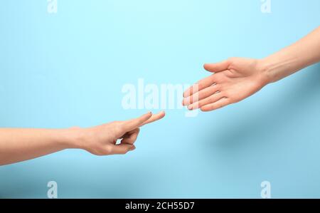 People playing roshambo game on color background Stock Photo - Alamy