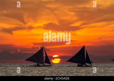 Local sailboats called paraw during afternoon in Boracay, Philippines ...