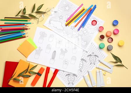 Composition with coloring pictures on table Stock Photo - Alamy