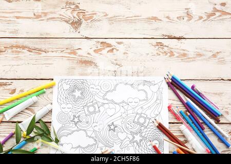 Composition with coloring picture on table Stock Photo - Alamy