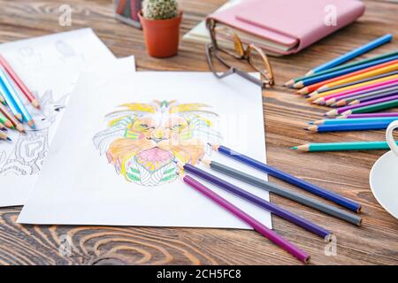 Composition with coloring pictures on table Stock Photo - Alamy