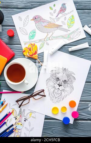 Composition with coloring pictures on table Stock Photo - Alamy