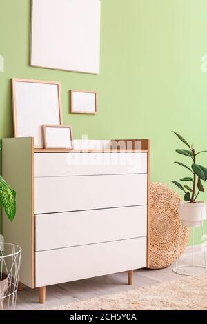 Chest of drawers and beautiful pictures in children's room. Interior ...