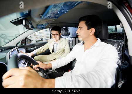 Man Testing New Car in Showroom Stock Photo - Alamy