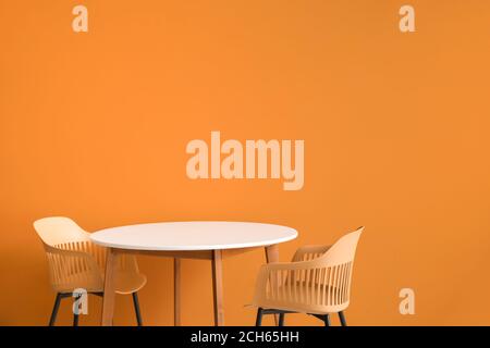 Dining table near color wall Stock Photo - Alamy