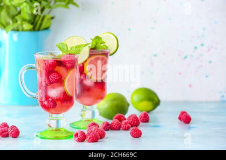 Cups of cold raspberry tea on table Stock Photo - Alamy