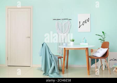Interior of room with stylish mint wall Stock Photo - Alamy