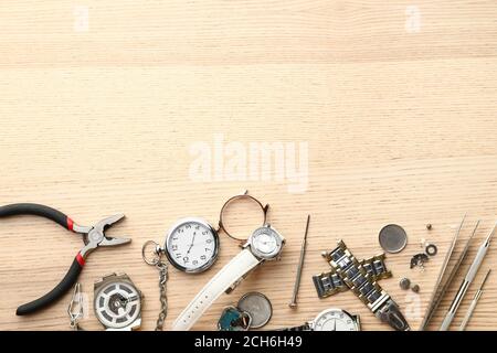 Broken watches and tools for repair on light background Stock Photo - Alamy