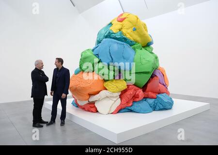 Jeff Koons (right) speaks with Damien Hirst (left) beside his sculpture ...
