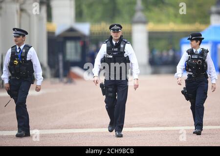 Police officers walk in front of the USA house ahead of the Annual ...