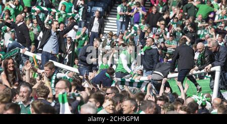 Hibernian fans sit on the goal posts after the William Hill Scottish ...