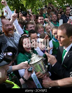 A Hibernian official shows the crowd the Scottish Cup at the Leith ...