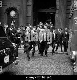 Messengers rushing from the Bank of England with announcement in change ...
