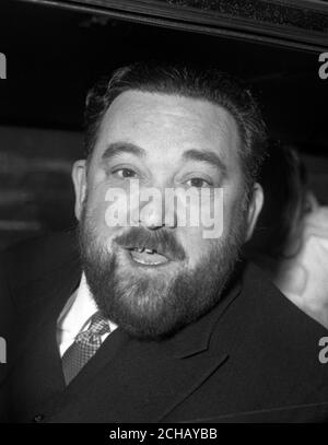 Singer-comedian Michael Flanders arrives by car at Buckingham Palace to ...