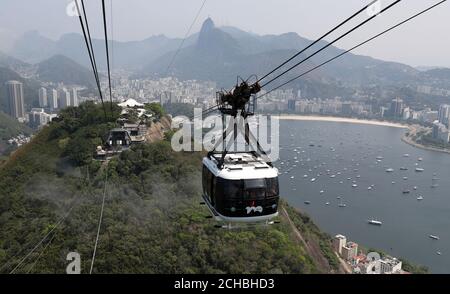 A cable car makes it's way up to the top of Sugarloaf mountain from ...