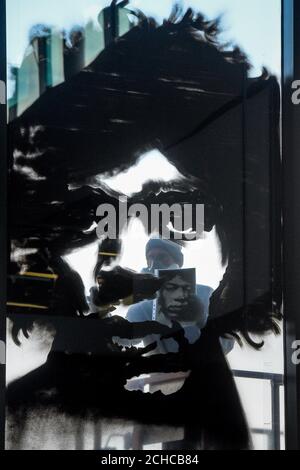 Bristol artist 'Voyder' works on a mural portrait of (left to right ...