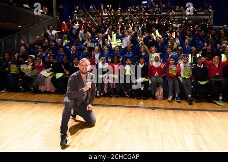 EDITORIAL USE ONLY Radio presenter Sam Pinkham with pupils from schools ...
