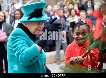 Queen Elizabeth II WITH Shylah Gordon, aged 8, and Coram CEO Carol ...