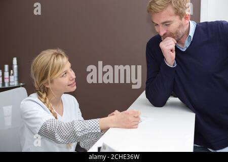 woman administrator and the client on the visitor reception Stock Photo ...