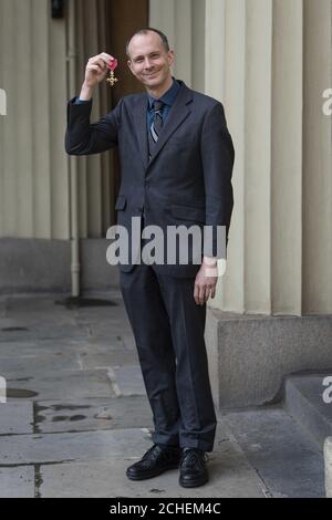 Economist and Journalist Tim Harford with his OBE after an investiture ...