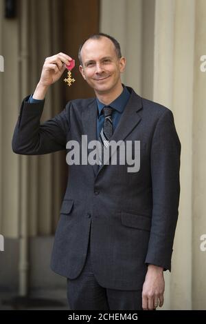 Economist and Journalist Tim Harford with his OBE after an investiture ...