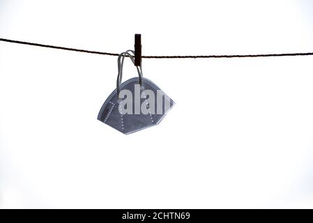 Face mask are hanging from rope on isolated white background Stock ...