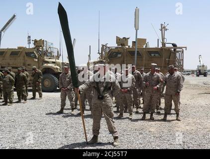 U.S. Marines stand in formation on the flight deck aboard the USN Wasp ...