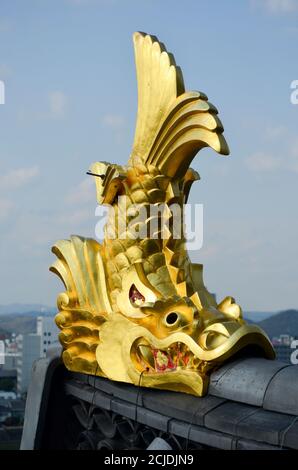 A golden fish sculpture (Shachihoko) on the roof of Okayama Castle ...