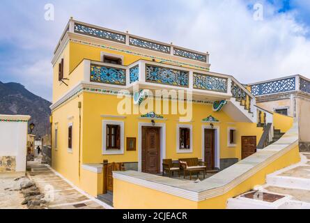 Charming two story yellow house with a large front porch on wooded lot ...