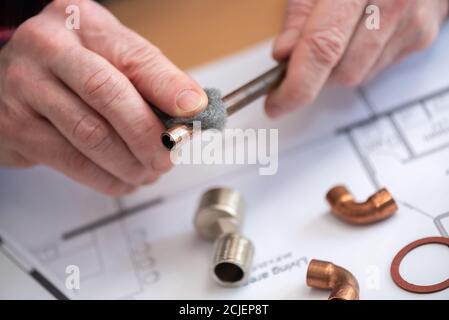 Plumber preparing a copper tube before welding; panoramic banner Stock ...